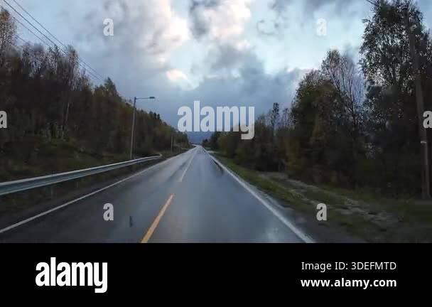 Point of view shot from a motorhome driving on a wet road through a ...