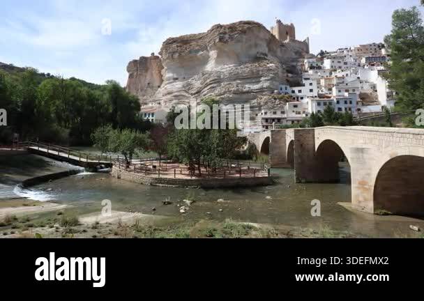 Famous medieval village Alcala del Jucar with its castle, Roman bridge ...