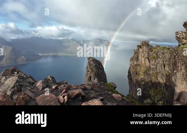Breathtaking view of a double rainbow disappearing over a majestic ...
