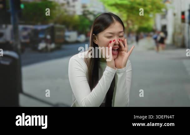 Woman shouting on urban street in daytime city setting surrounded by ...