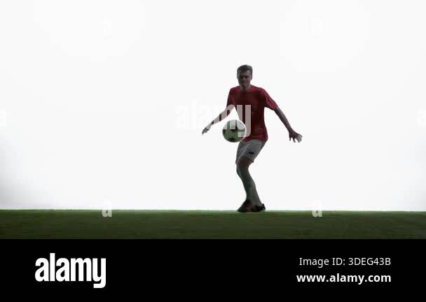 Powerful soccer side volley shot in mid air at white studio. Concept of ...