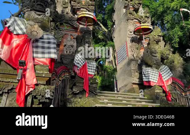 Traditional Balinese stone guardian statues at Hindu temple entrance in ...