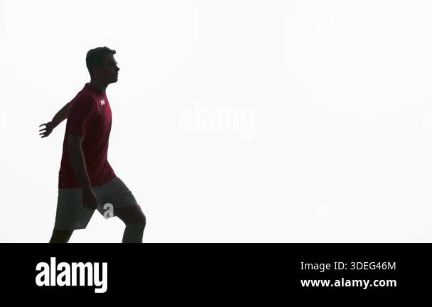 Dynamic football player controlling ball mid air in studio. Concept of ...