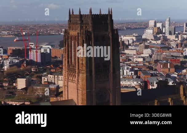 Aerial dawn pan centers the sandstone lantern of Liverpool Cathedral ...