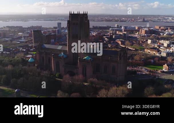 Aerial sunrise scene in Liverpool, UK. The drone glides past Liverpool ...