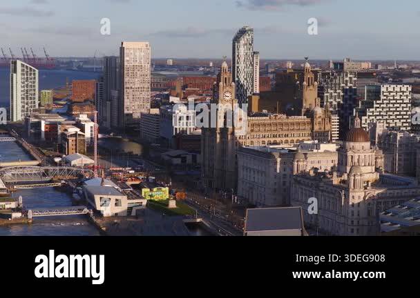 Aerial wide view at sunrise shows Royal Liver Building, clock towers ...