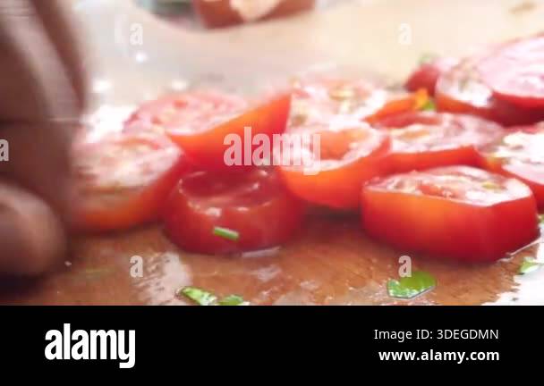 Sliced red tomatoes on wooden cutting board Stock Video Footage - Alamy