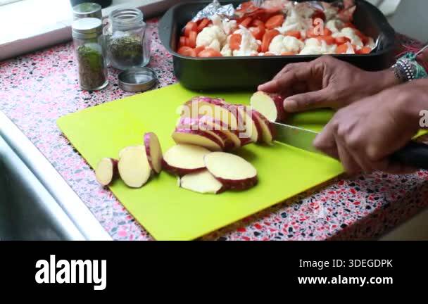 Slicing sweet potatoes on green cutting board Stock Video Footage - Alamy