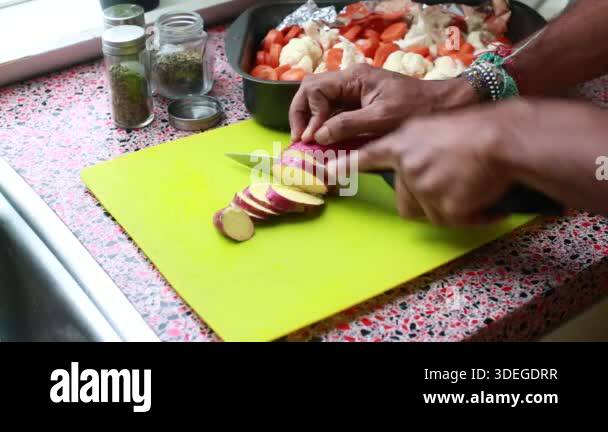 Slicing sweet potato on green cutting board Stock Video Footage - Alamy