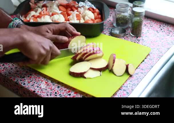 Slicing sweet potatoes on cutting board Stock Video Footage - Alamy