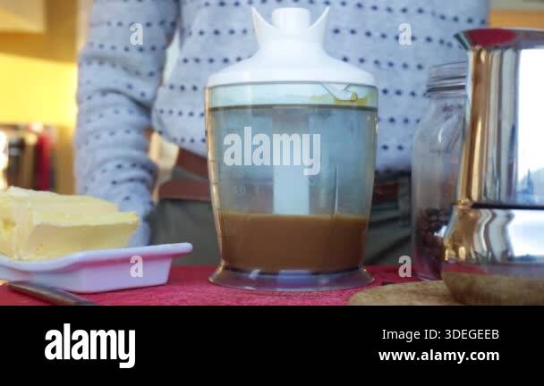 Person making ketogenic bulletproof coffee at home for breakfast Stock ...