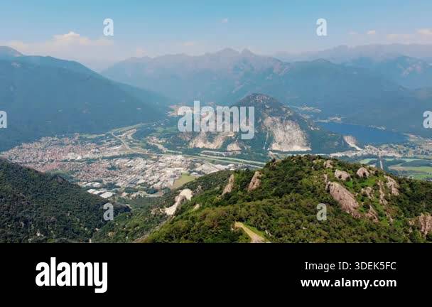 Panoramic view of populated area between mountain slopes and lake ...