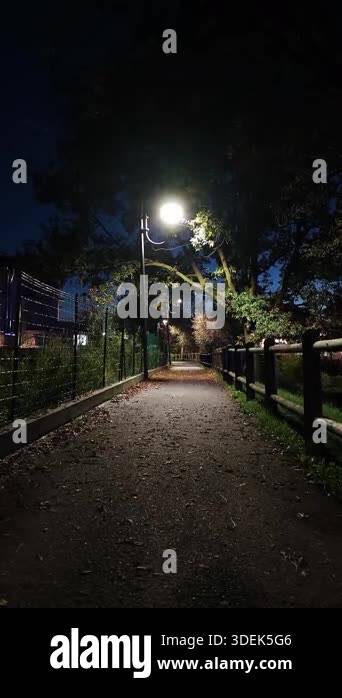 Night river in northern Italy town with street lighting reflection in ...