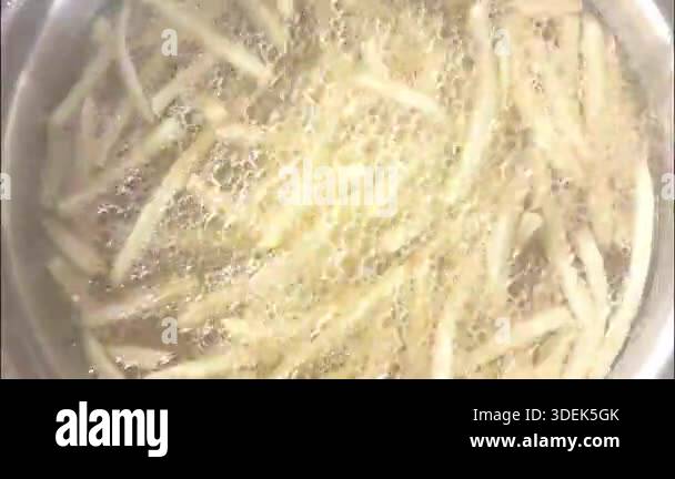 Frying French fries or deep-fried potato sticks in pan Stock Video ...