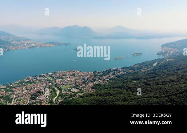 Mountain ranges and lake shrouded in morning haze. Atmospheric view of ...