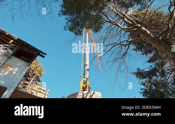 Tower construction crane for cottage construction in Italian mountain ...