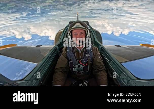 Smiling male pilot in military uniform flying jet plane above white ...