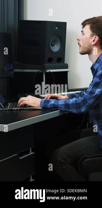 Sound engineer mixing and mastering song in front of computer and ...