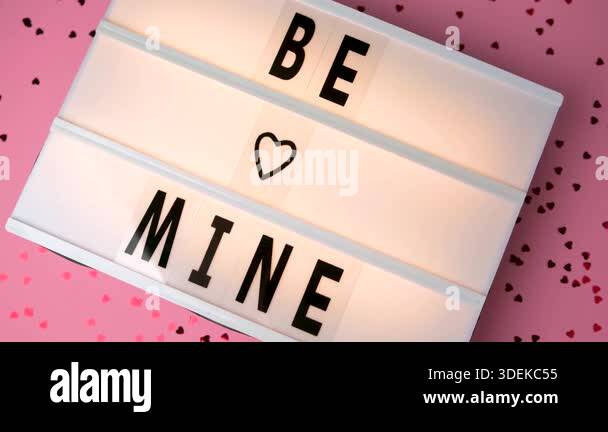 Illuminated lightbox displaying romantic 'Be Mine' message with heart ...