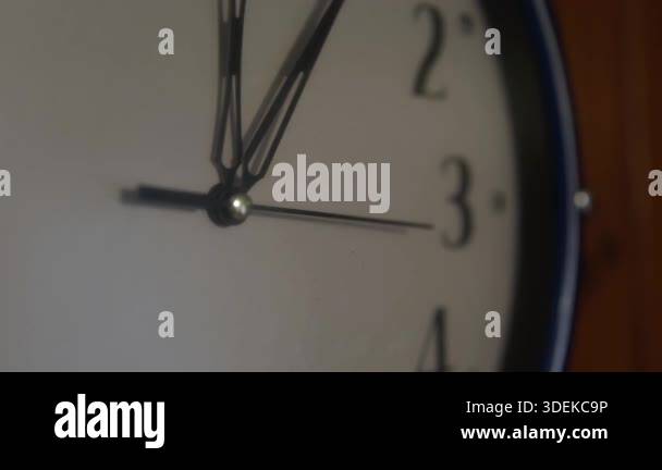 Close-up of analog wall clock with shallow focus, quiet moment of ...