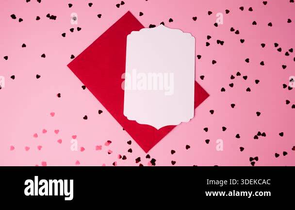 Blank card and red envelope with scattered heart confetti on pink ...
