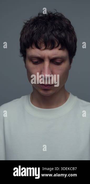 Man looking down with tense expression and inner emotional state ...
