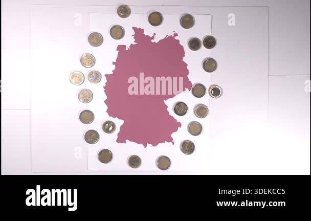 Stop-motion video of Euro coins merging into a map of Germany, focusing ...