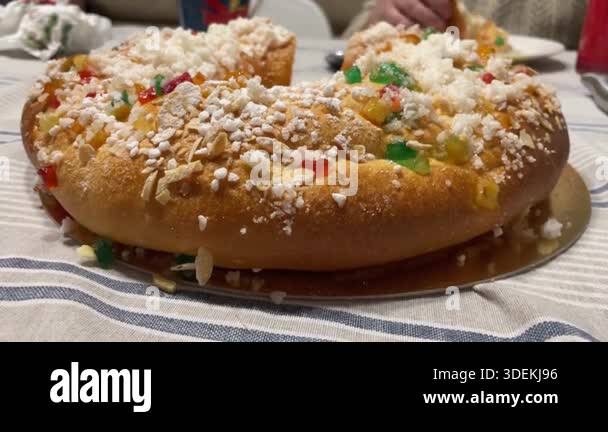 Zoom-out from blurred Roscon de Reyes, family enjoying traditional ...