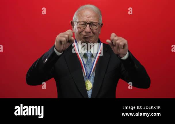 Senior man in business suit mimics crying gesture with fingers, wearing ...