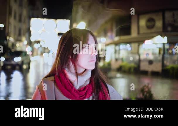 Charming young woman with a red scarf smiling and sending a kiss to the ...