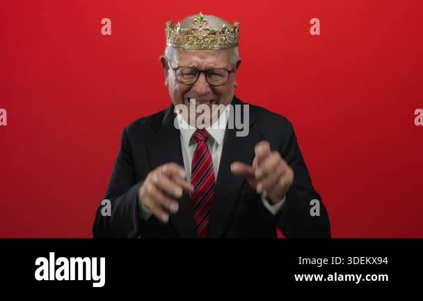 Senior man in business suit and crown making scared expressions against ...