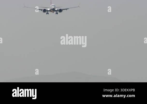 Passenger jet airplane with unrecognizable livery landing. Commercial ...