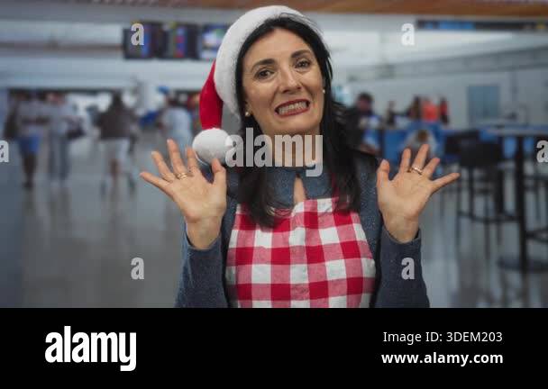 Woman wearing red and white gingham apron smiles while holding strap ...
