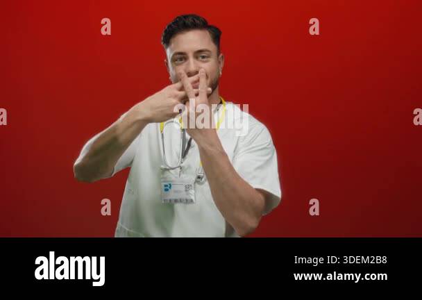 Young man doctor gesturing hashtag with fingers wearing stethoscope and ...