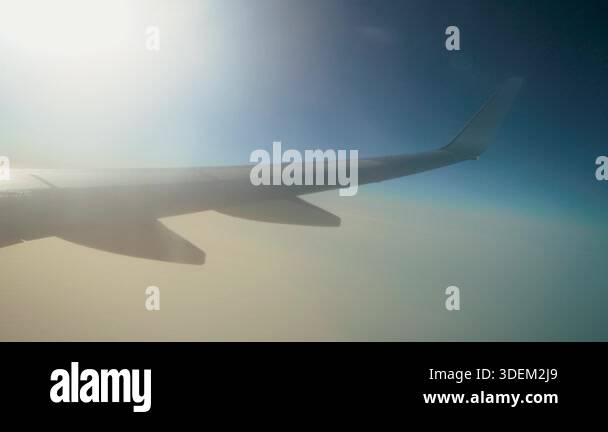 Airliner flying through eerie mist in gloomy weather. Jet cruising in ...