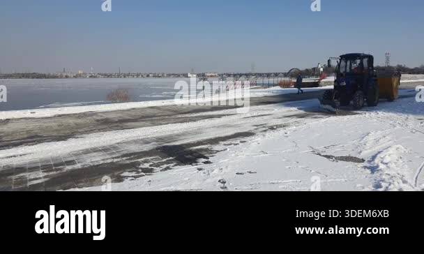 Dnipro, Ukraine, 12-28-2025. Winter cleaning of city streets. A tractor ...