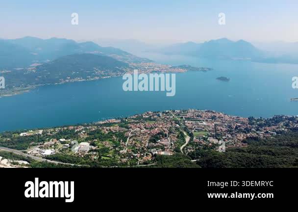 Overhead view of lake and coastal settlement from mountains in daytime ...