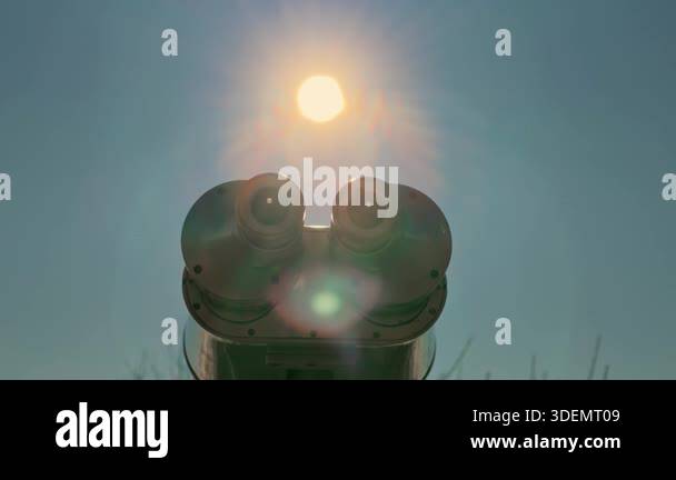 Closeup of tourist binoculars at viewing platform with sun flare in ...