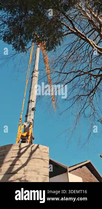 Construction tower crane rising above residential buildings in alpine ...