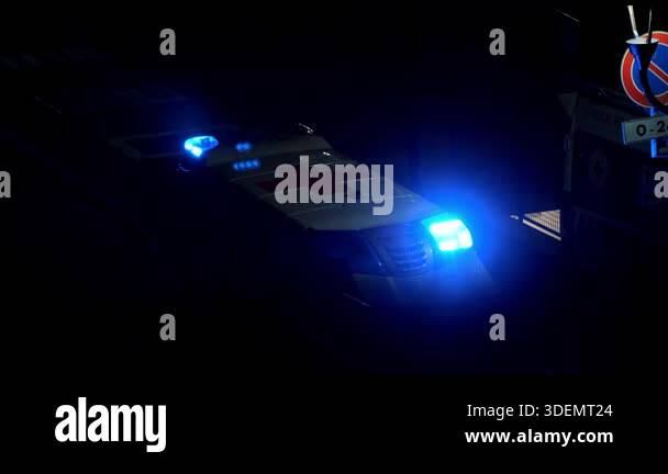 Ambulance vehicle with blue emergency lights parked on night street ...