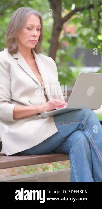 Old Woman with Migraine Using Laptop while Sitting Outdoor on Bench ...