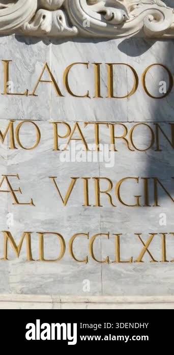 Close up of Latin inscription on marble facade of San Placido Church in ...