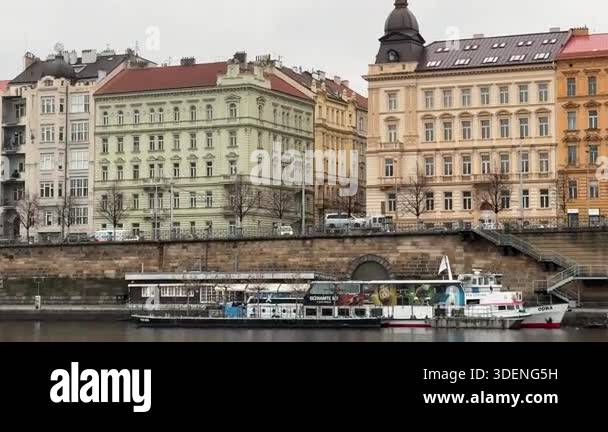 Prague Vltava river embankment with historic buildings and Charles ...