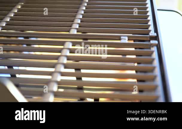 Close-up reveals the pristine griddle of a new two-burner grill ...