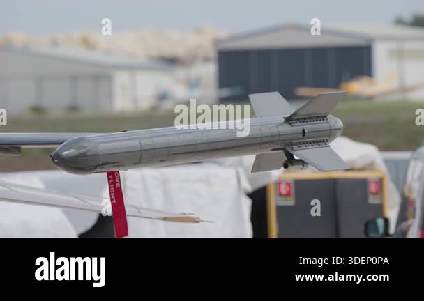 External auxiliary fuel tank mounted on underwing pylon of military ...