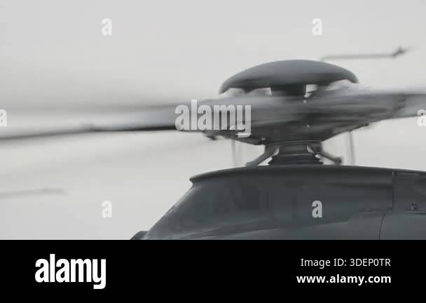 Distant view of a military helicopter flying steadily in open sky with ...