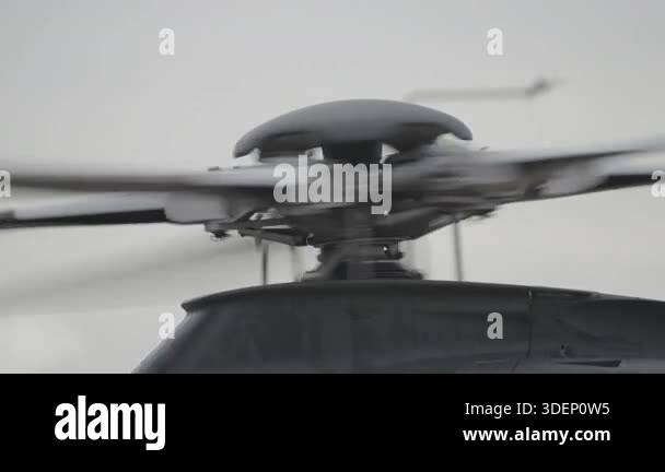 Close up view of a helicopter main rotor spinning rapidly showing ...