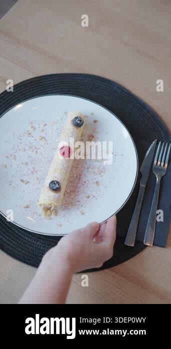 Rolled sweet pastry garnished with fresh blueberries and raspberries ...