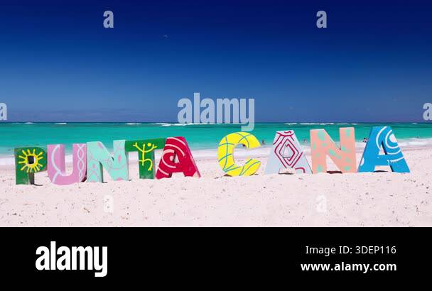 Colorful text Punta Cana Sign on the beach sand and Caribbean sea on ...