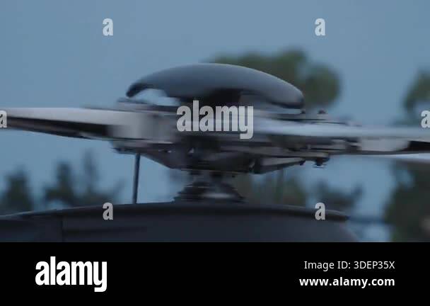 Close view of helicopter main rotor spinning at high speed illustrating ...